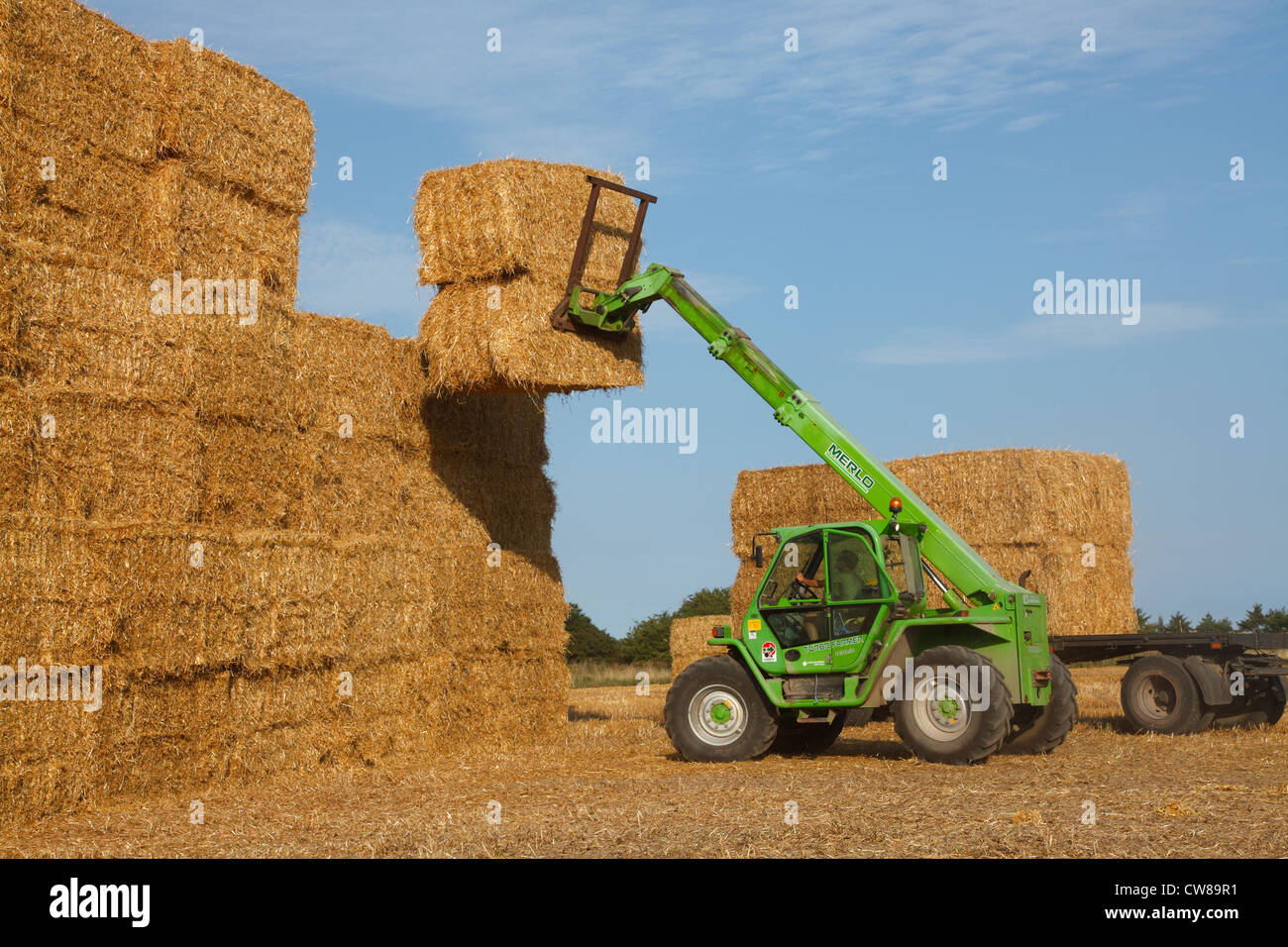 Turbofarmer lift stacking big straw bales on a field in Lynge, North ...