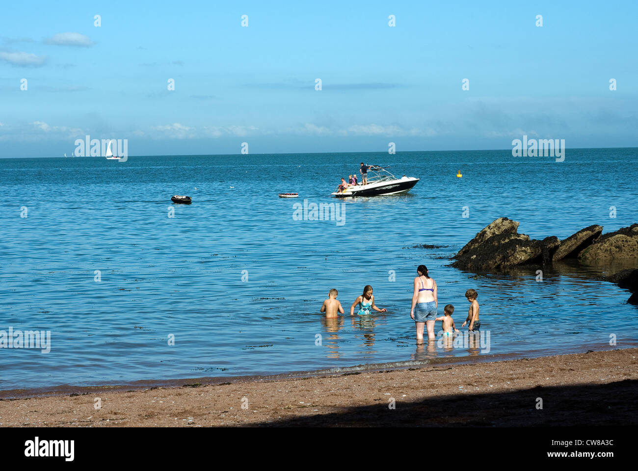 Children paddling at Watcombe beach,Devon,A small sandy cove set to the ...