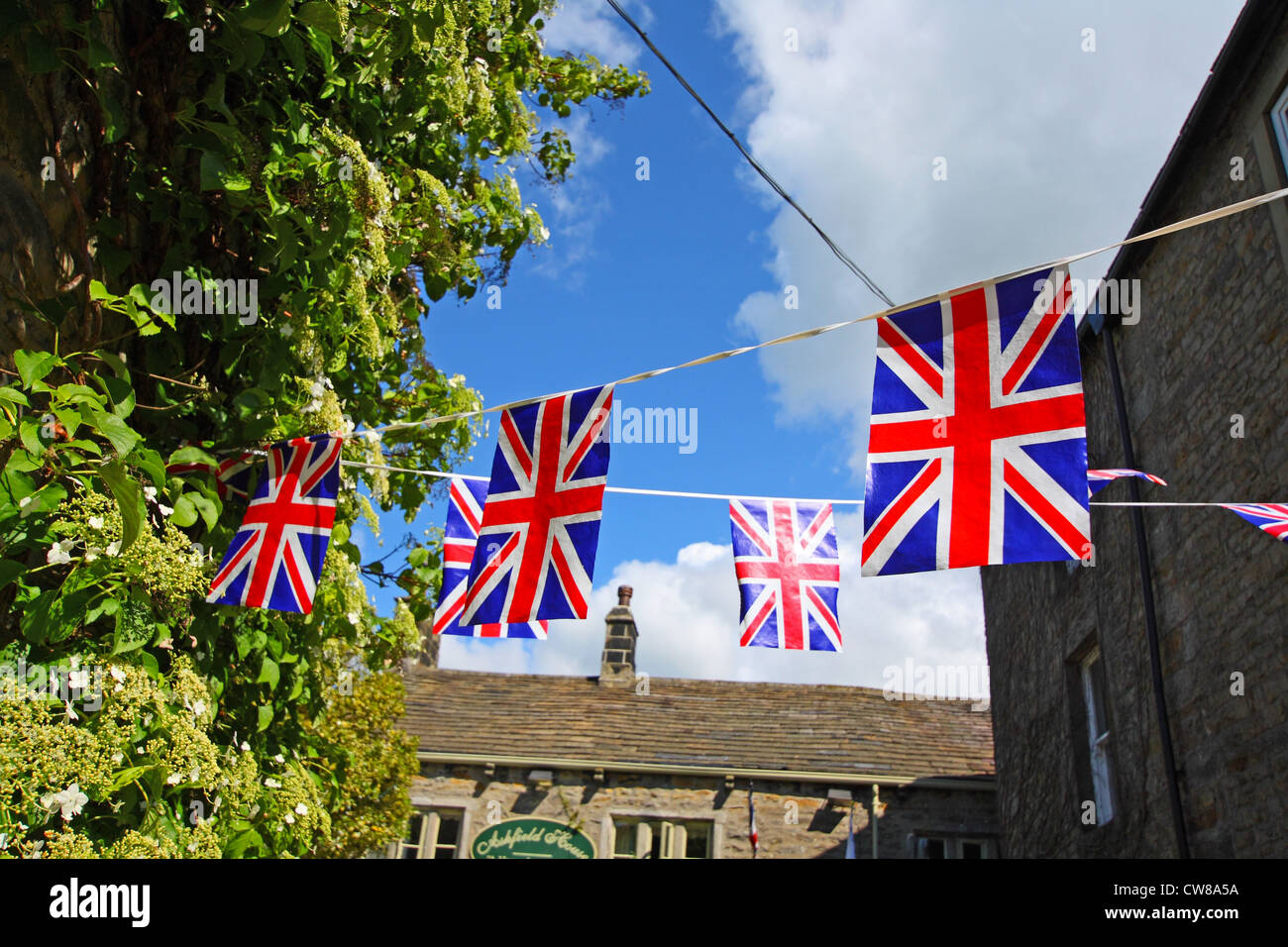 British flags hanging in the streets of small English town Stock Photo ...