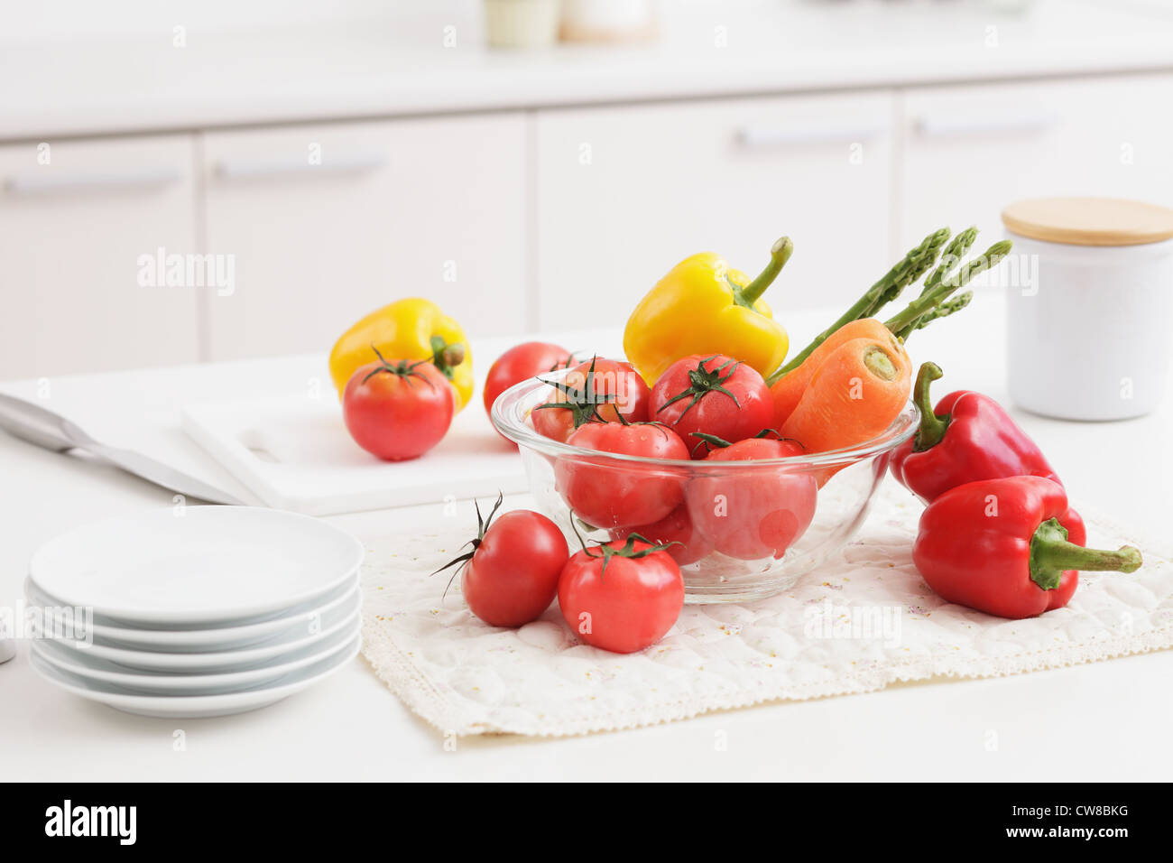 Vegetables And Plates On Kitchen Counter Stock Photo - Alamy