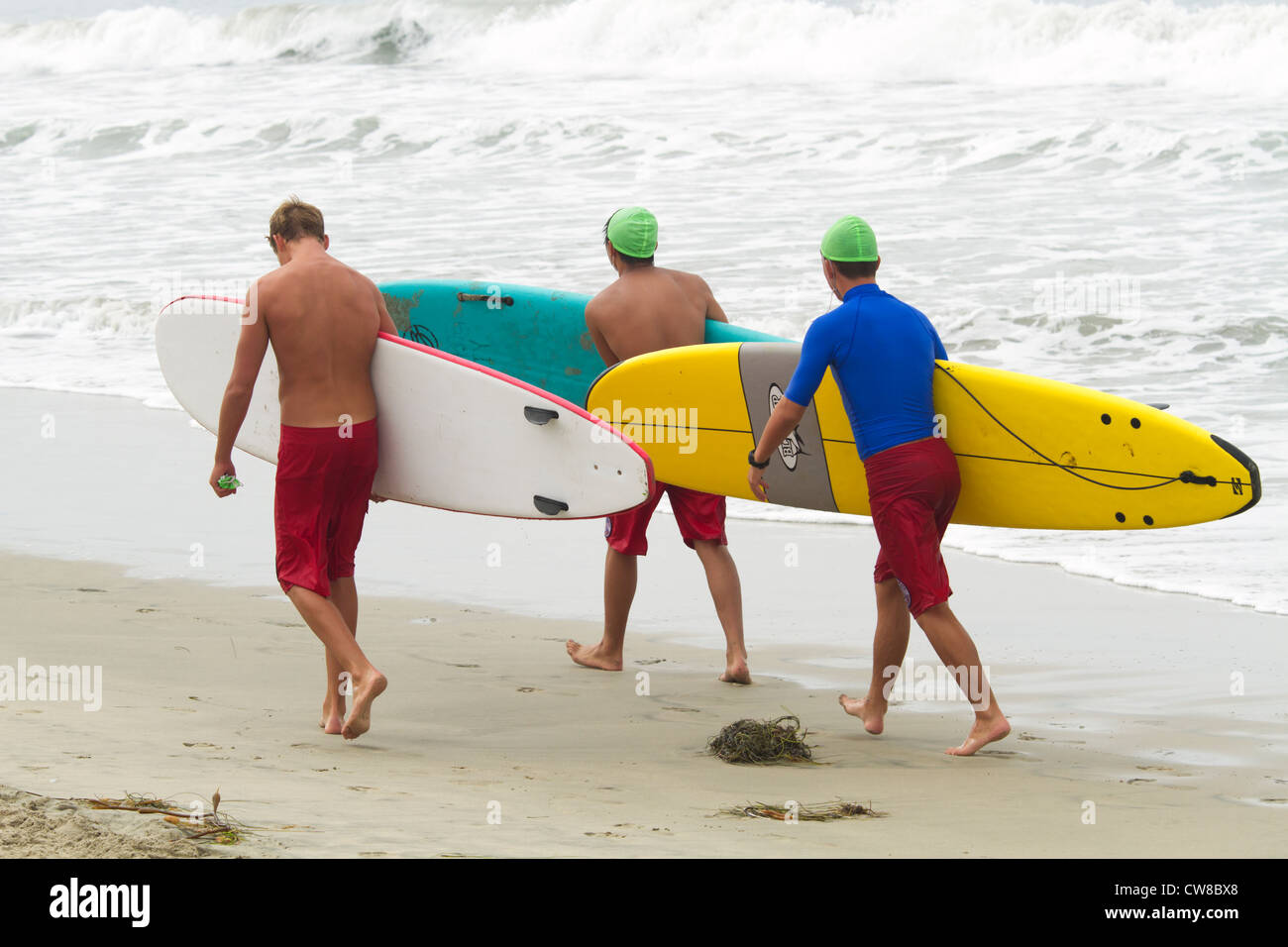 Junior lifeguards carrying surfboards to a training exercise Stock ...