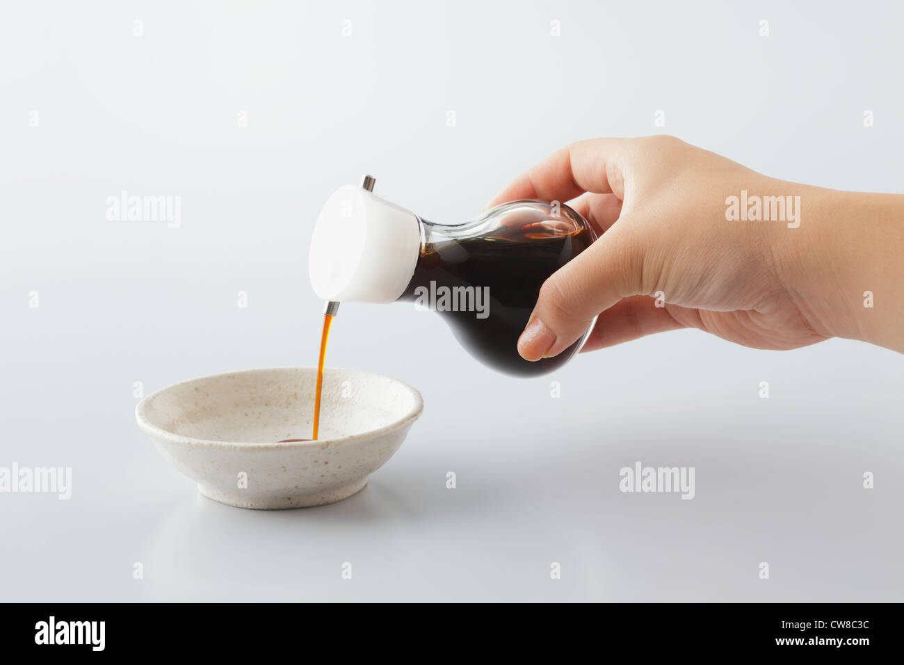 Human Hand Pouring Oil In Bowl Stock Photo - Alamy