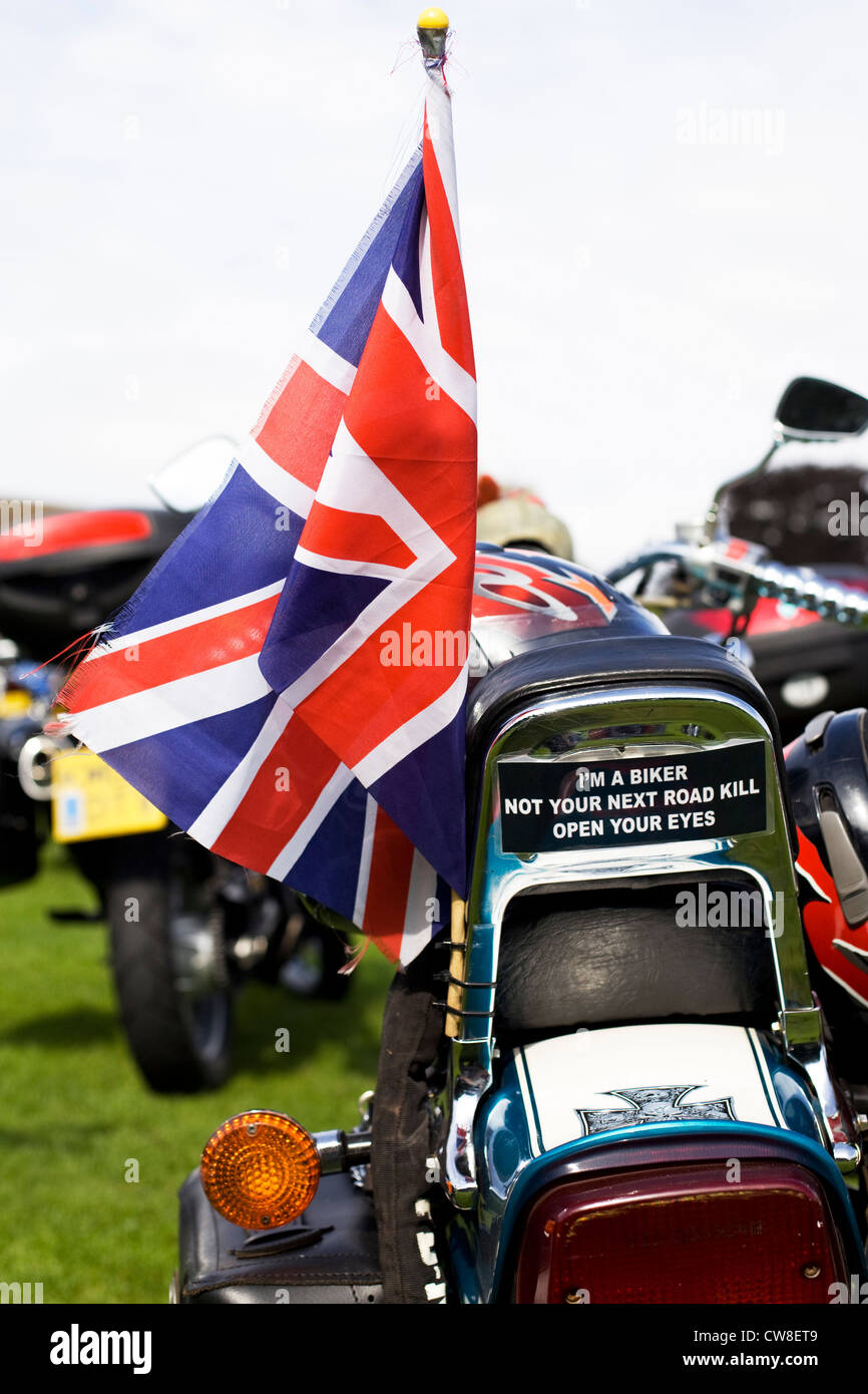 Harley Davidson with a Union jack Flag and a plaque saying " I'm a ...