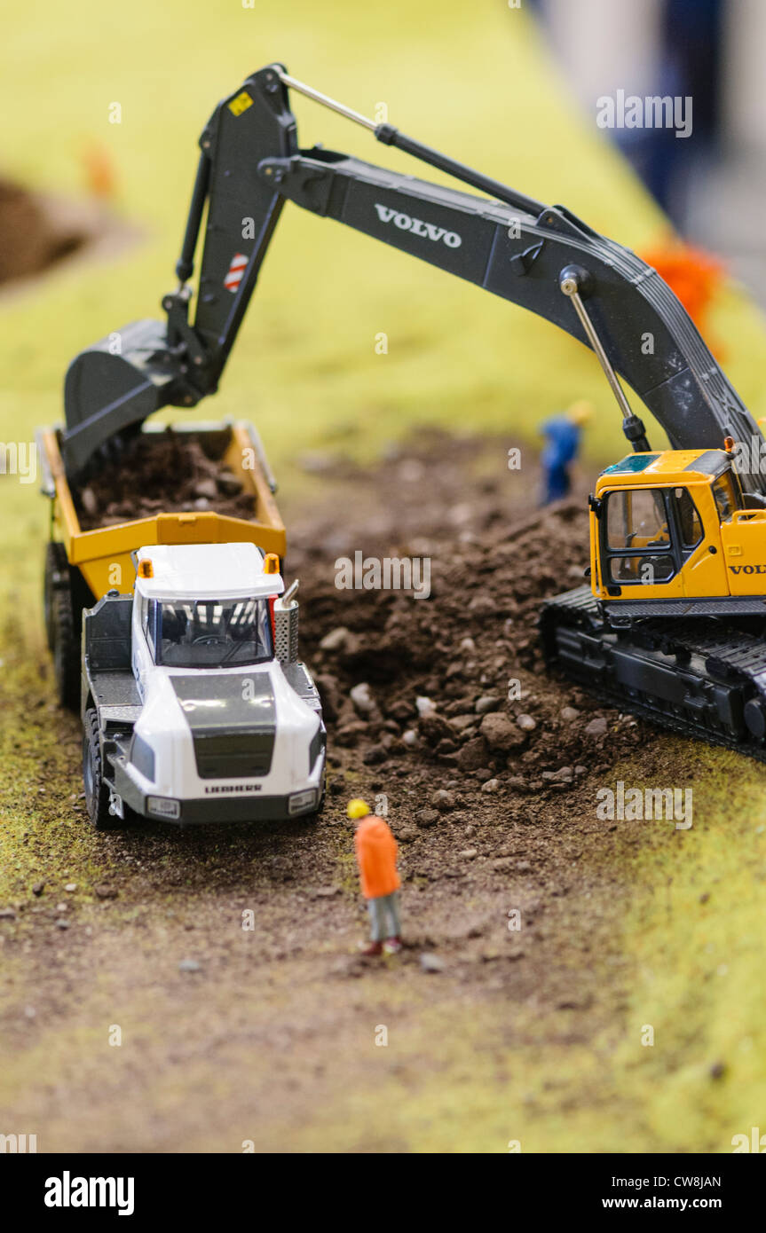 Models of a Volvo digger and Leibherr dumpster truck Stock Photo - Alamy