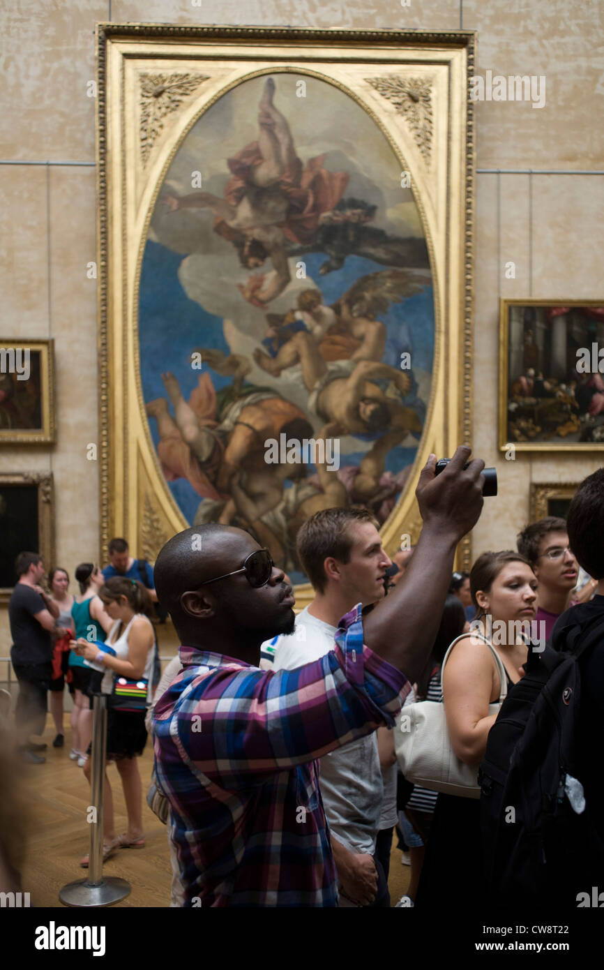 Tourist uses a digital camera to record the Mona Lisa in the Louvre ...