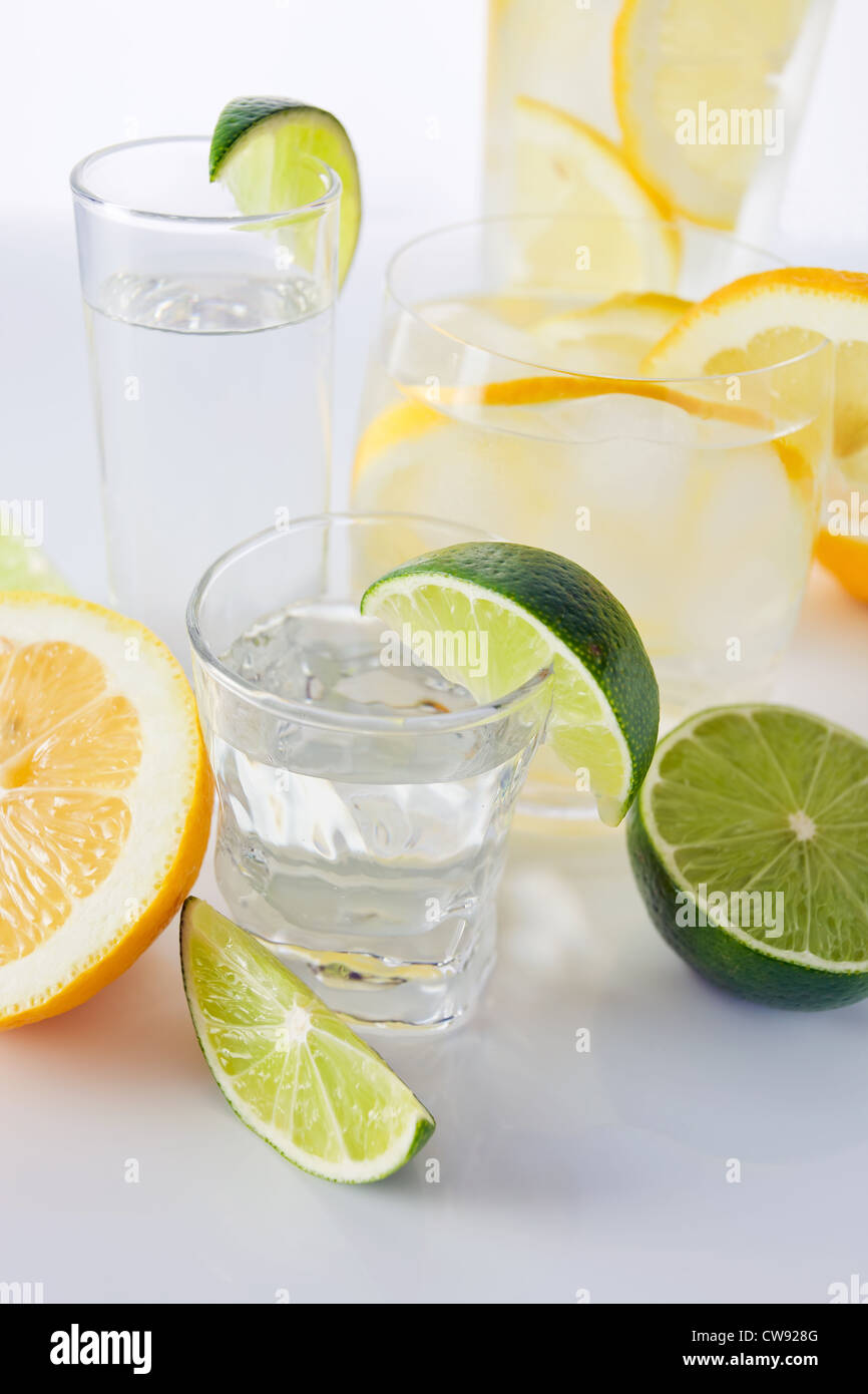 drinks with lemon and lime, shot on reflective white background Stock ...