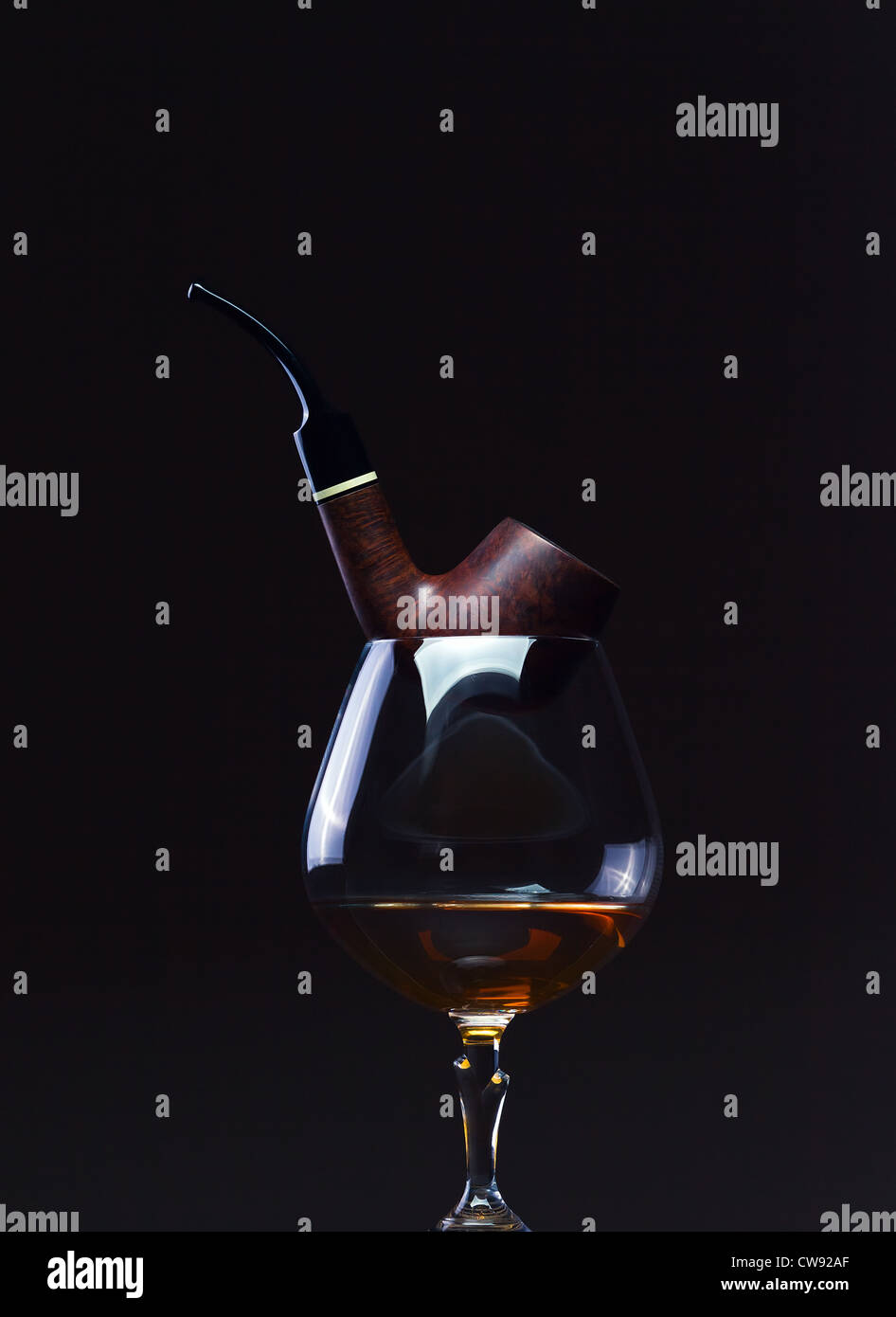 cognac and pipe on a dark background Stock Photo - Alamy