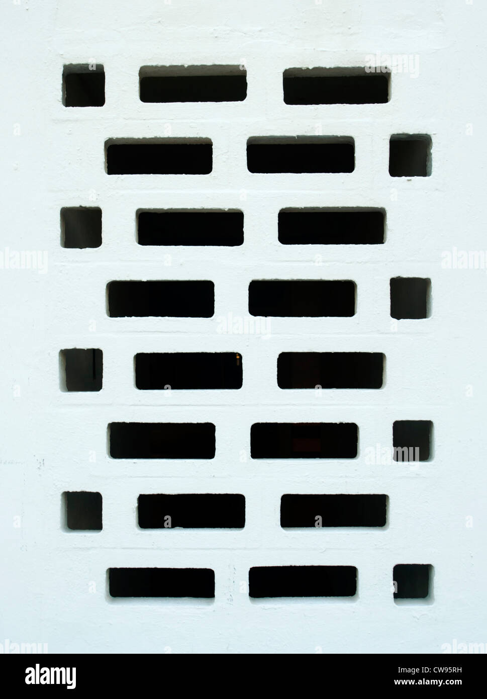 Geometric white textured and patterned wall with rectangular holes for ...