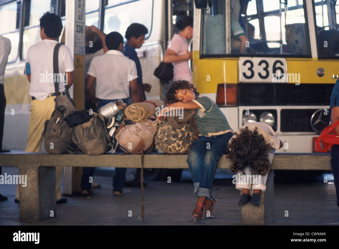 Homeless family children with possessions at bus station sleeping ...