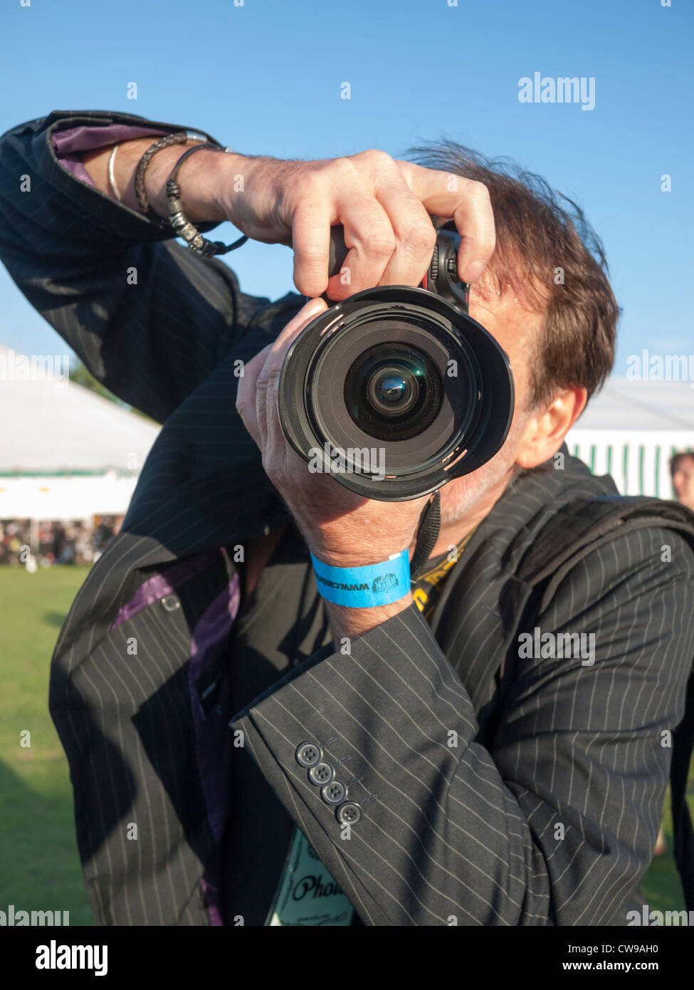 A photographer close up pointing camera and taking a picture directly ...