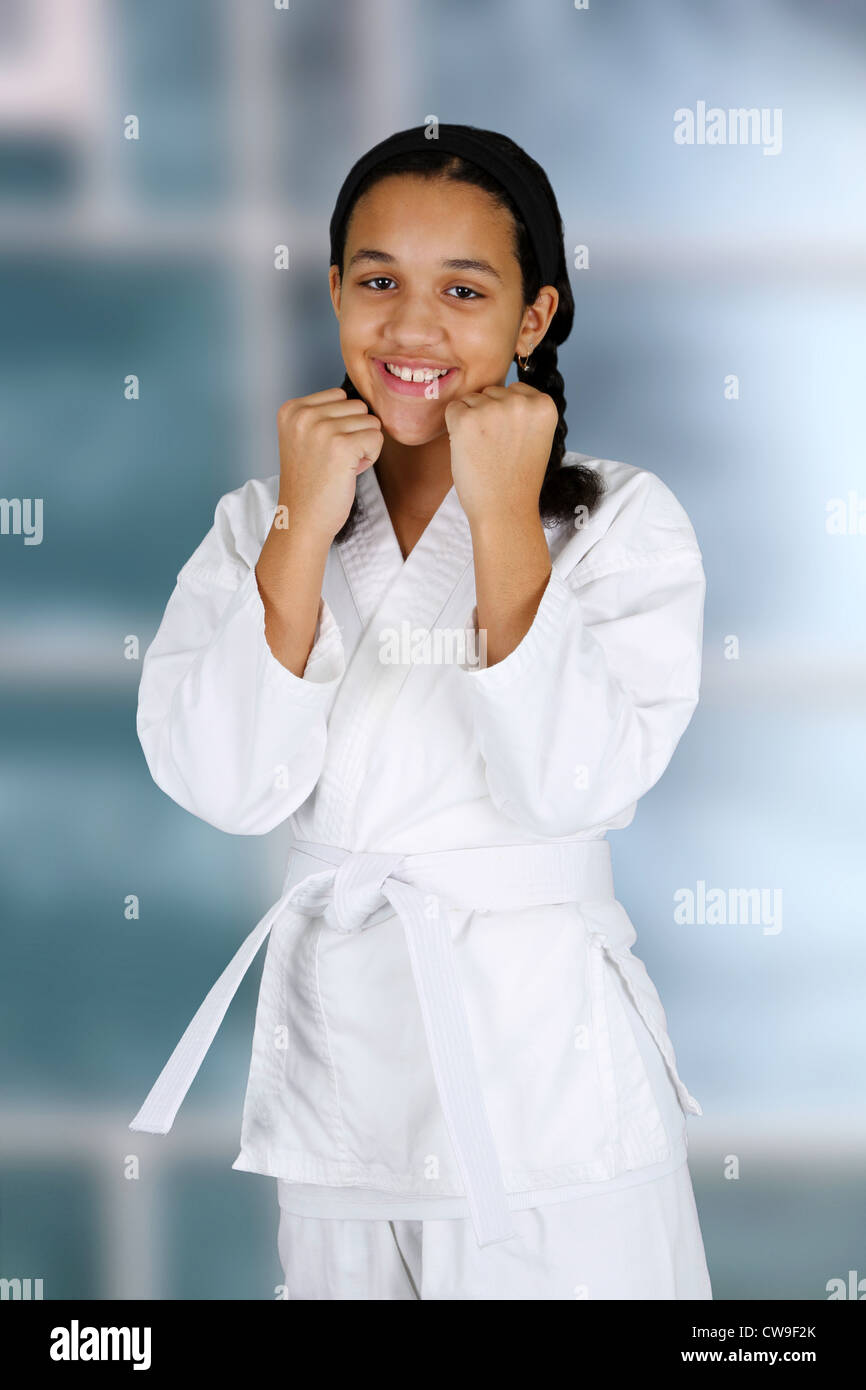 Teen girl doing karate at a studio Stock Photo - Alamy
