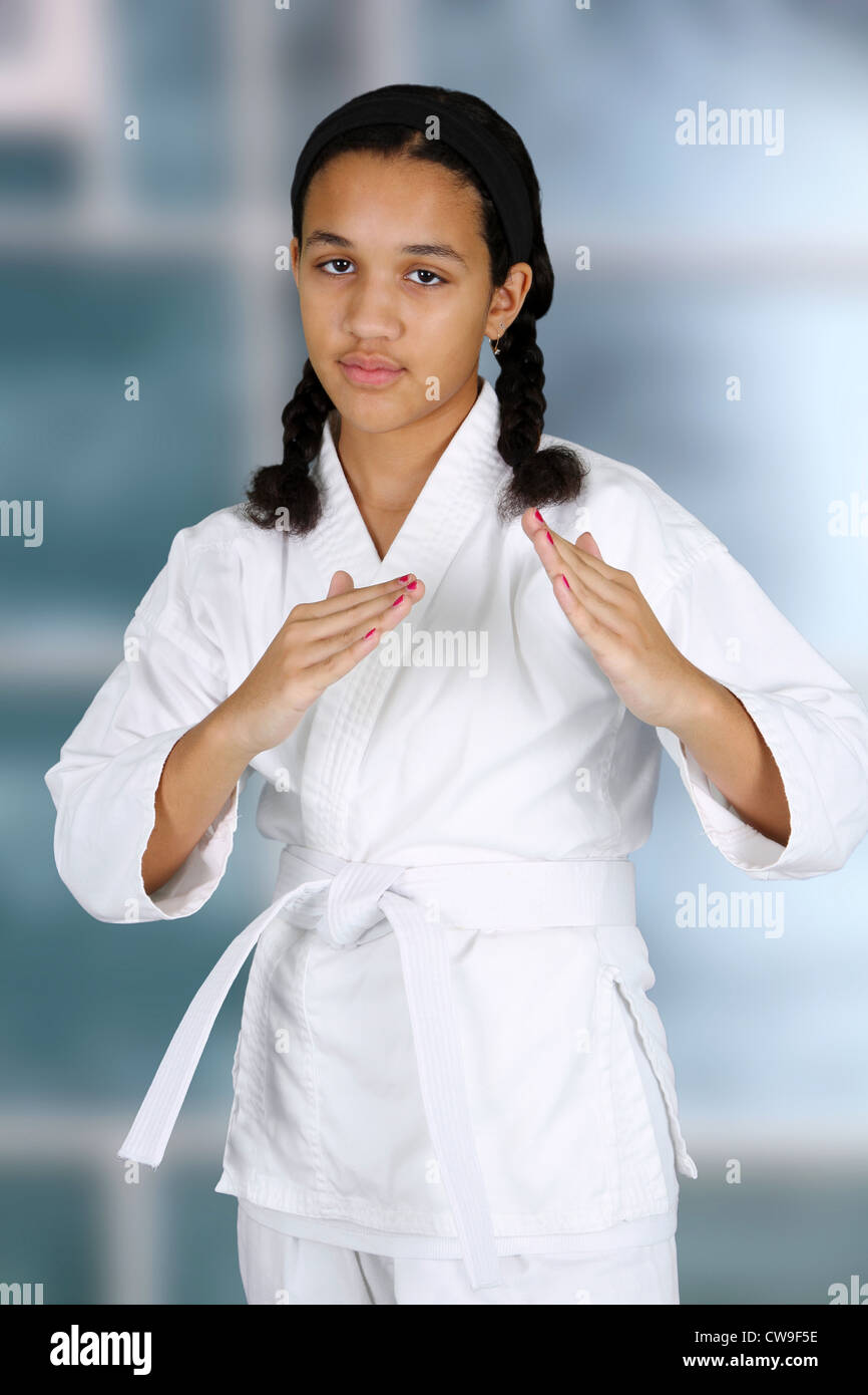 Teen girl doing karate at a studio Stock Photo - Alamy