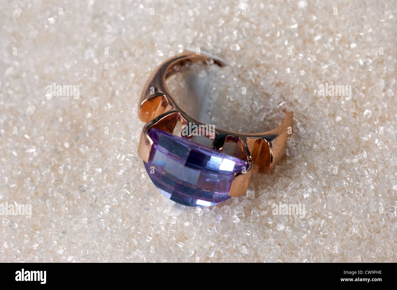 gold ring with a ruby on a background of small shiny objects Stock ...