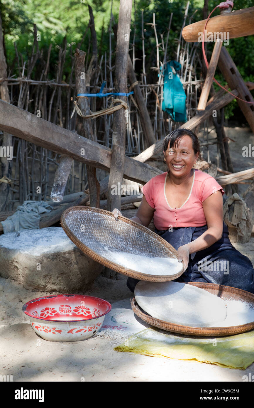 Myanmar, Burma, near Bagan. Village Woman Sifting Ground Rice. Her ...