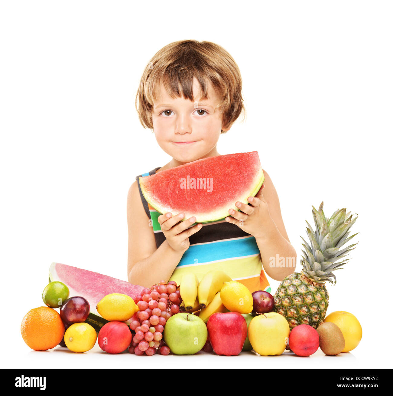 Boy eating a watermelon, standing behind fruits isolated on white ...