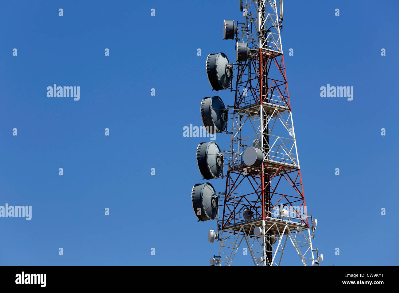 Communication mast set against blue sky Stock Photo - Alamy