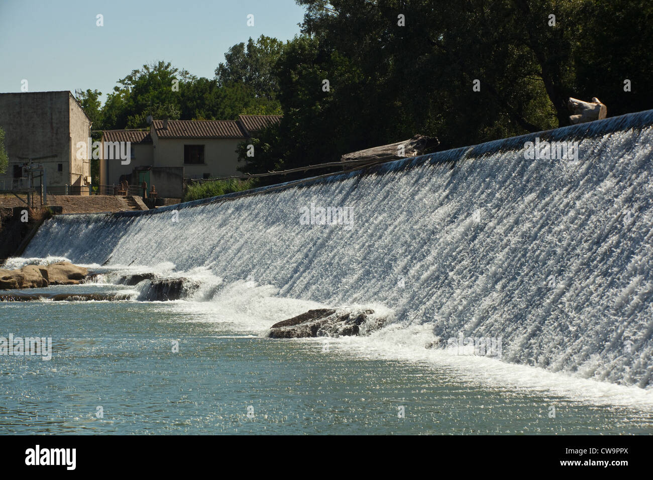 Logs and branches sit atop a weir across the River Aude in Carcassonne ...