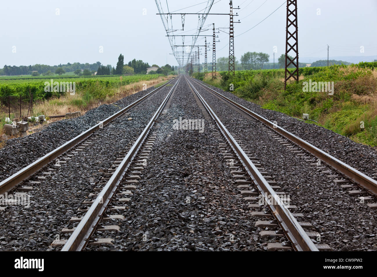 A dual rail track viewed from the center point in the rain Stock Photo ...