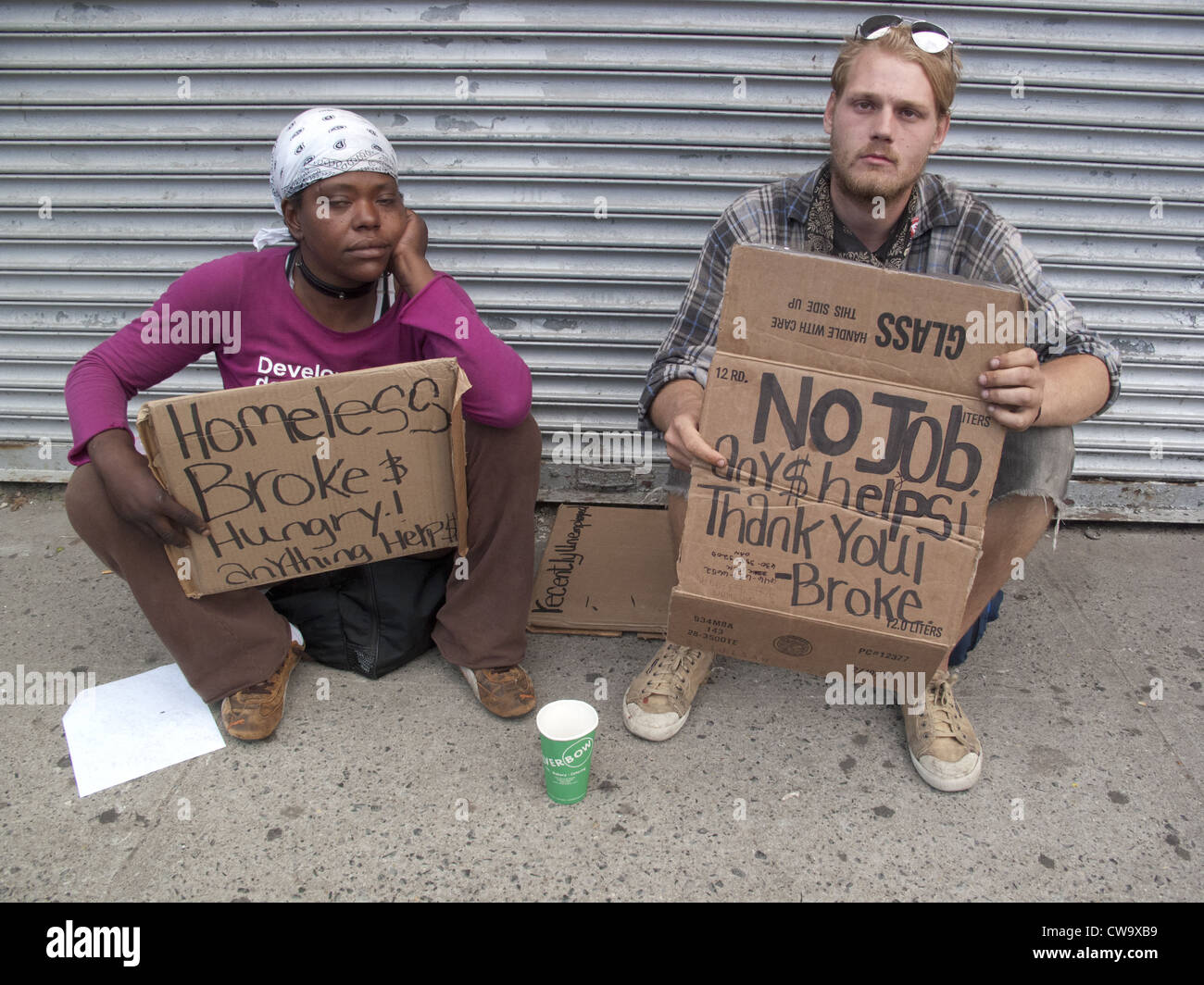 Homeless, young man and woman panhandling in Coney Island, 2010 Stock ...