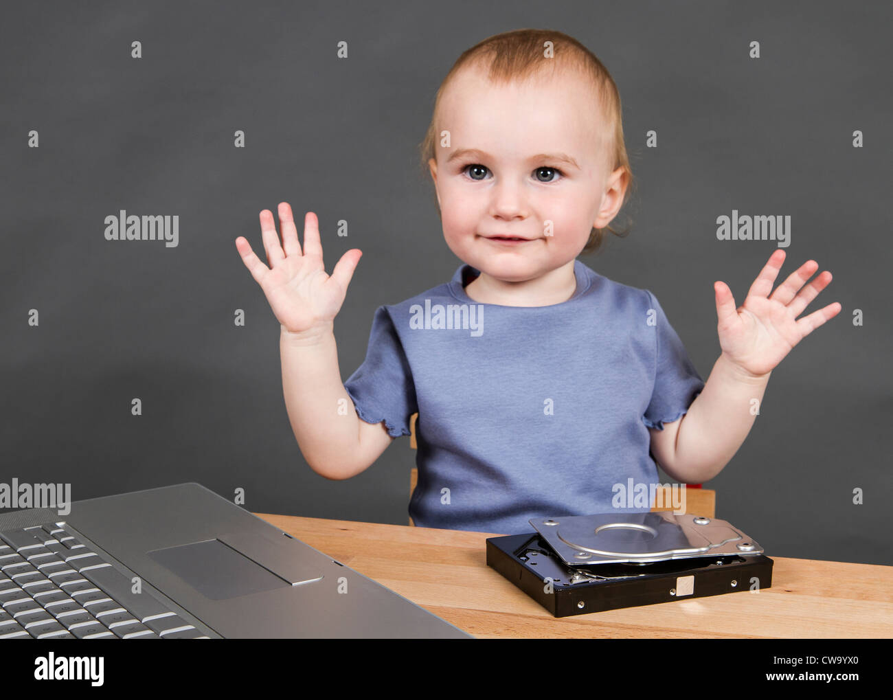 child with open hard drive and laptop computer in grey background Stock ...