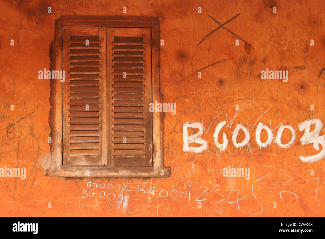Orange house with shuttered window, Ghana Stock Photo - Alamy