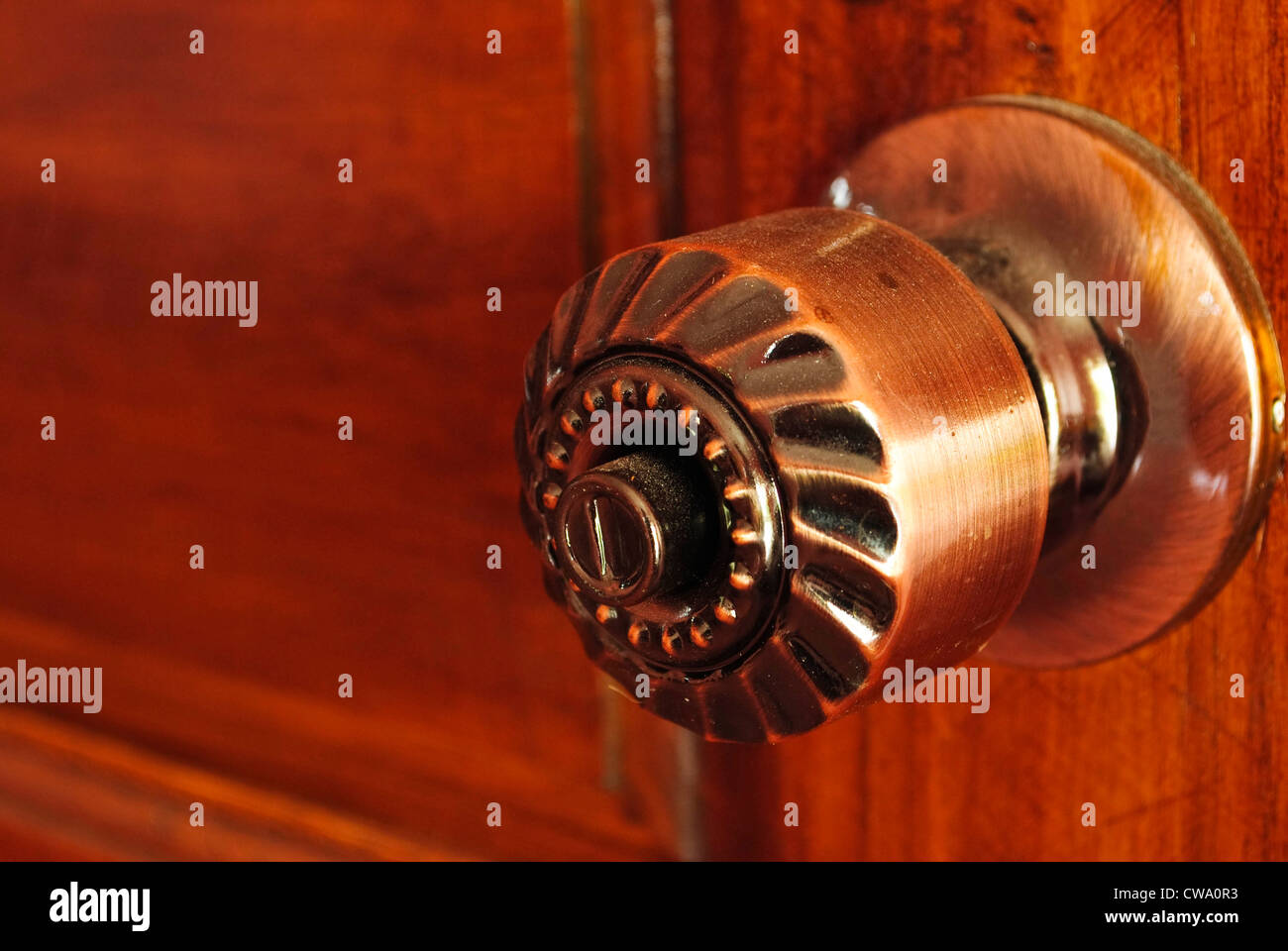 Color photo of a metal handle on a wooden door Stock Photo - Alamy