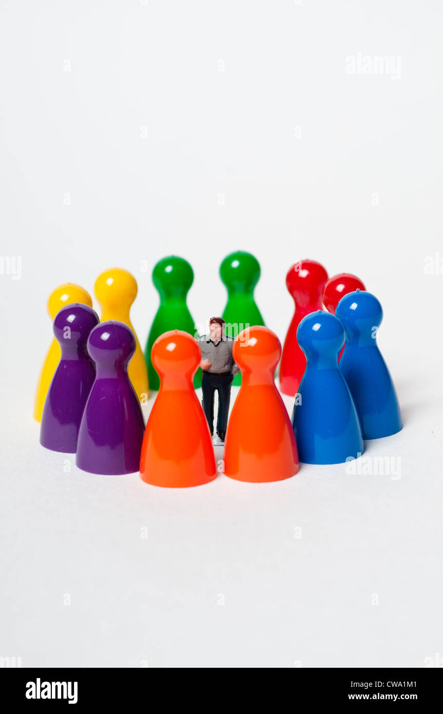 Colourful pawns encircling a toy figure Stock Photo - Alamy