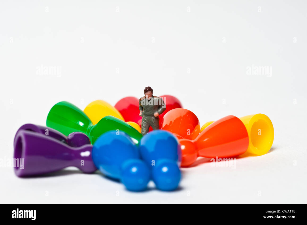 Colourful pawns and a toy figure Stock Photo - Alamy