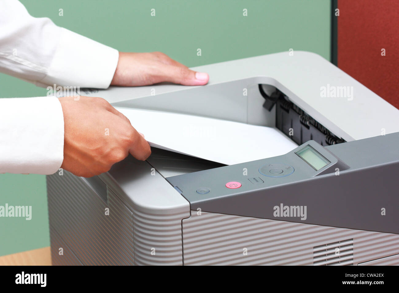 Businessman working with printer in the office Stock Photo - Alamy