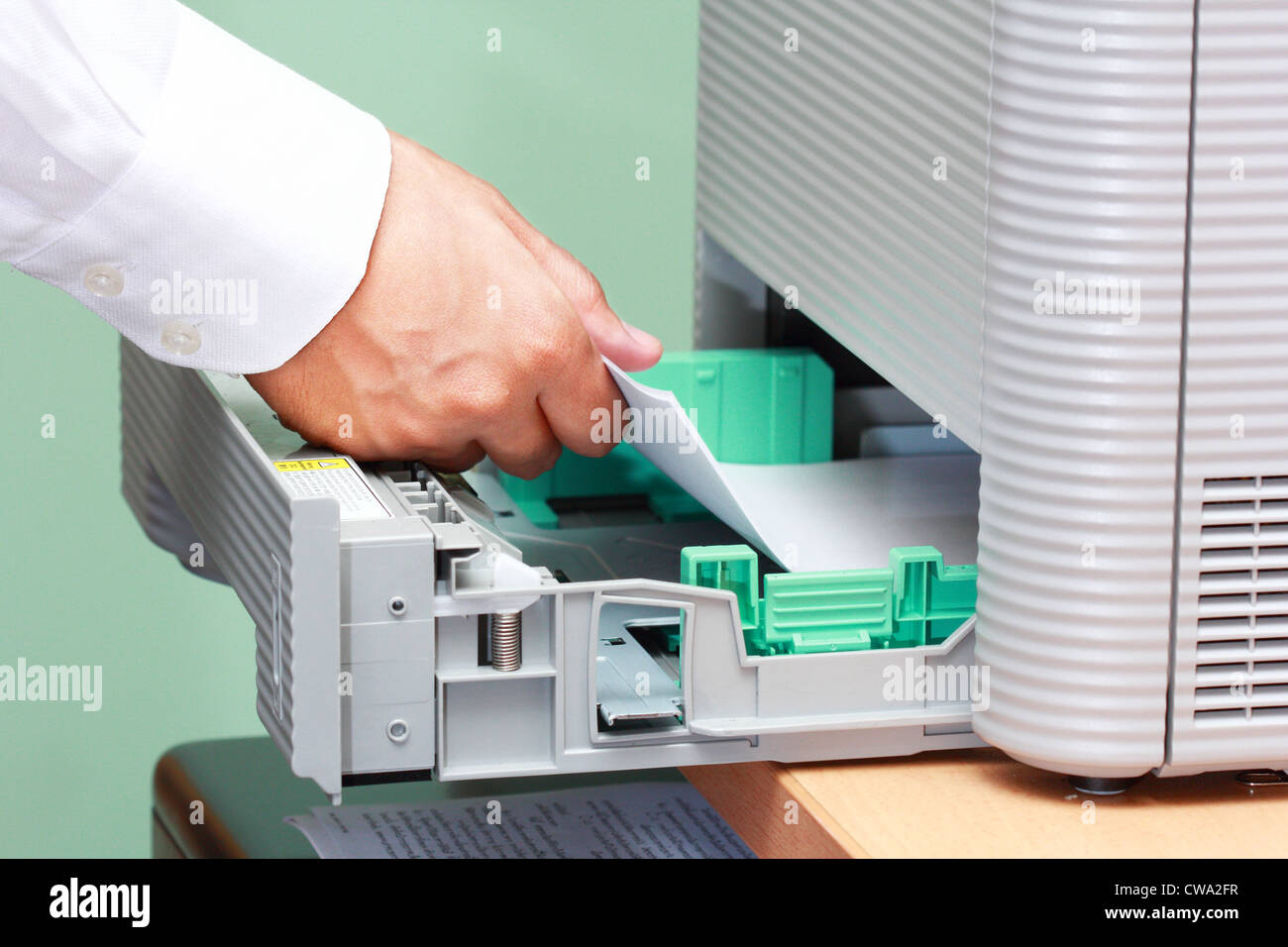 Businessman working with printer in the office Stock Photo - Alamy