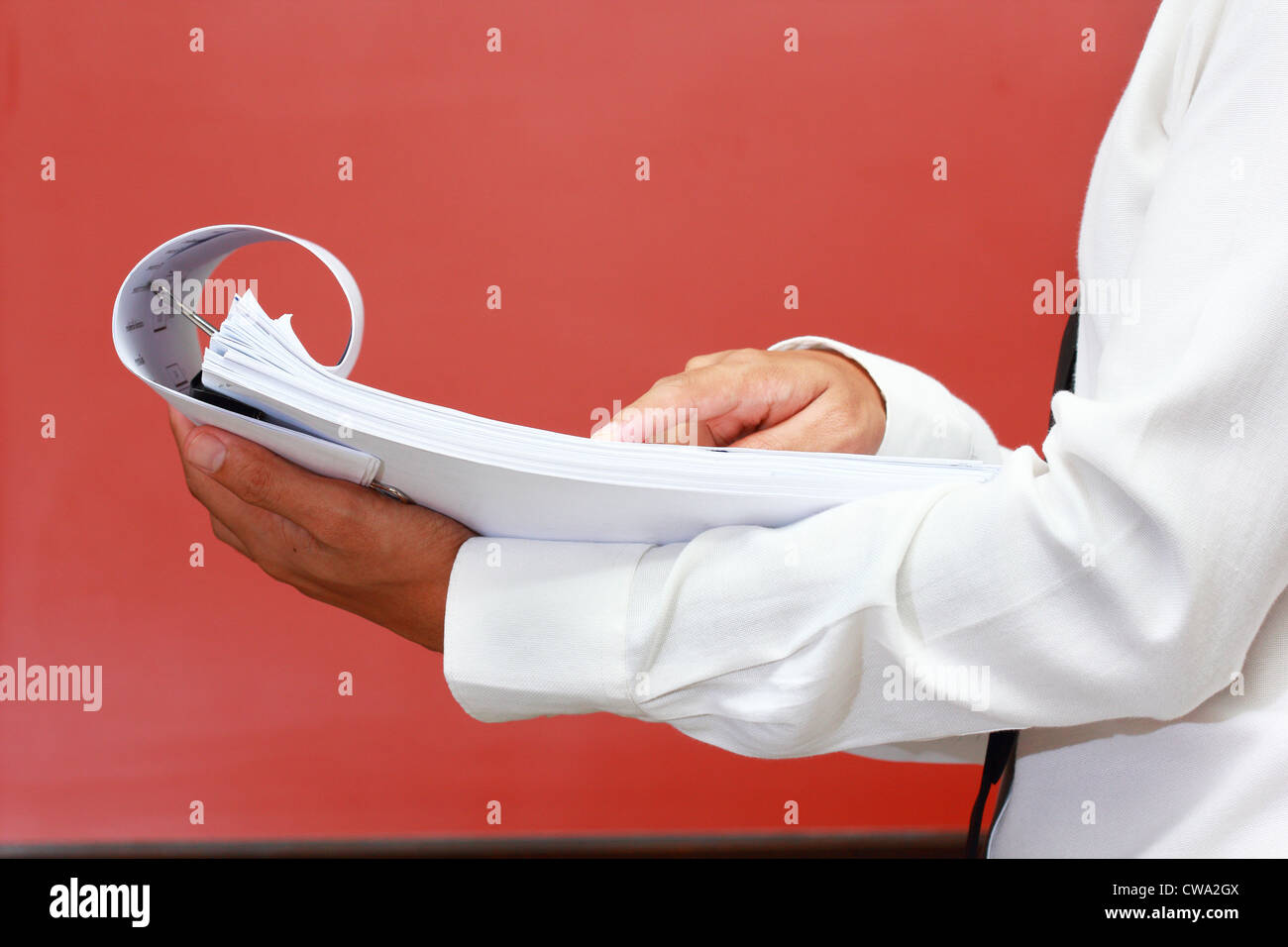 a worker man analyzing pile of paper Stock Photo - Alamy