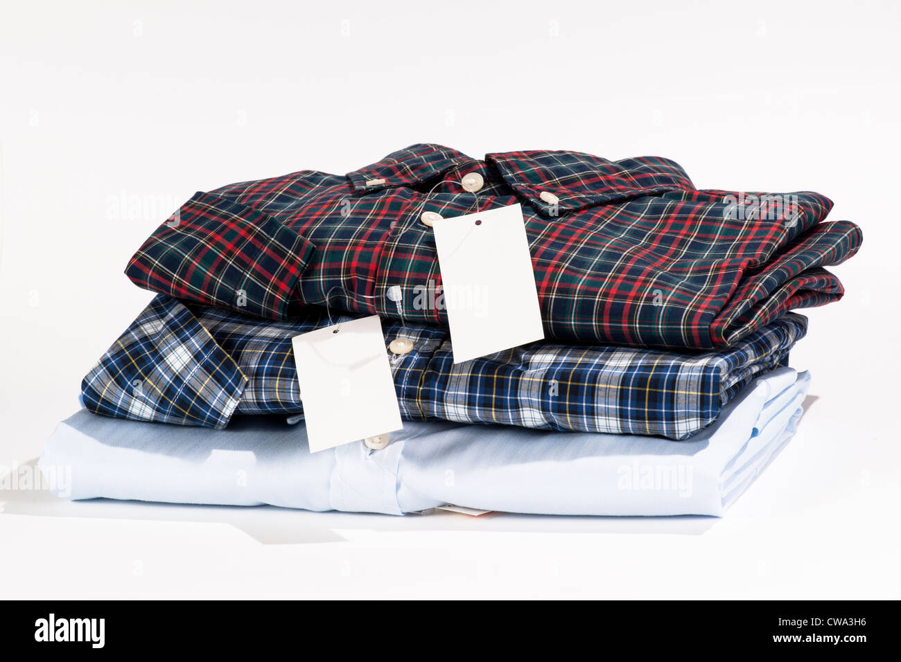 Stack of folded shirts with blank label Stock Photo - Alamy