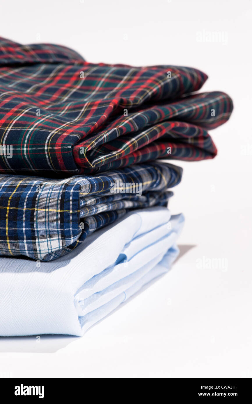 Stack of folded shirts with blank label Stock Photo - Alamy