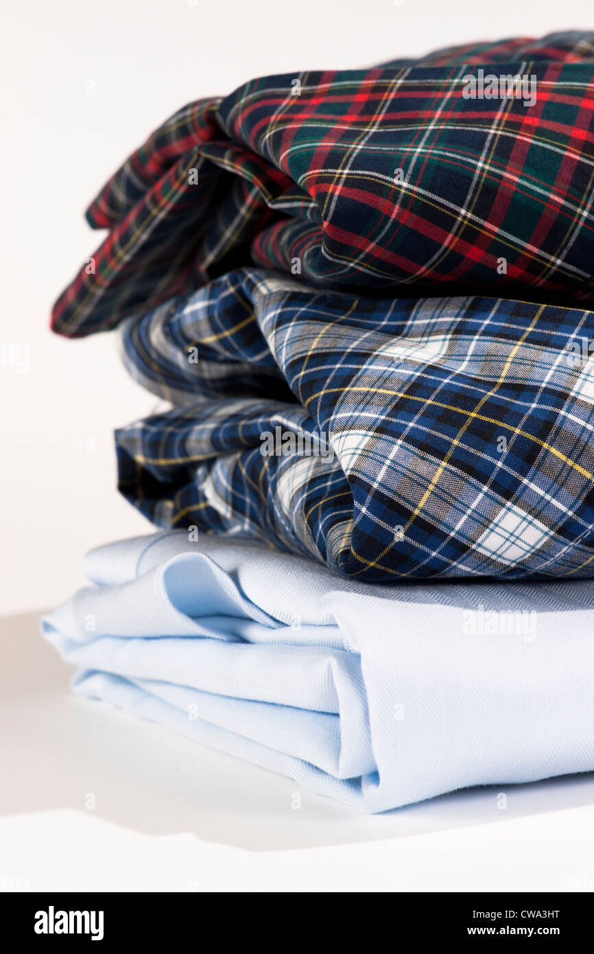 Stack of folded shirts with blank label Stock Photo - Alamy