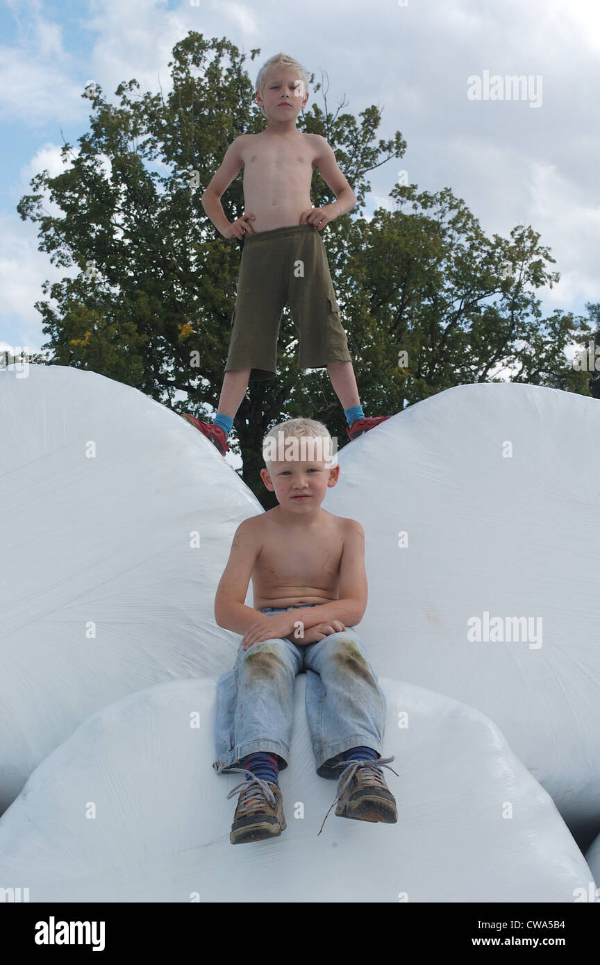 Two boys posing for the camera Stock Photo - Alamy