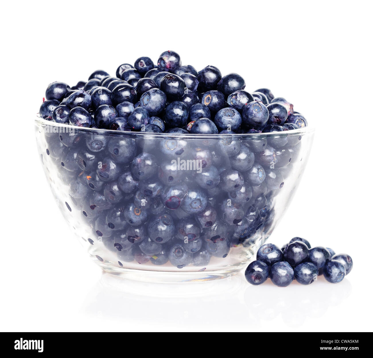 Blueberries in transparent glass dish with soft shadow on white ...