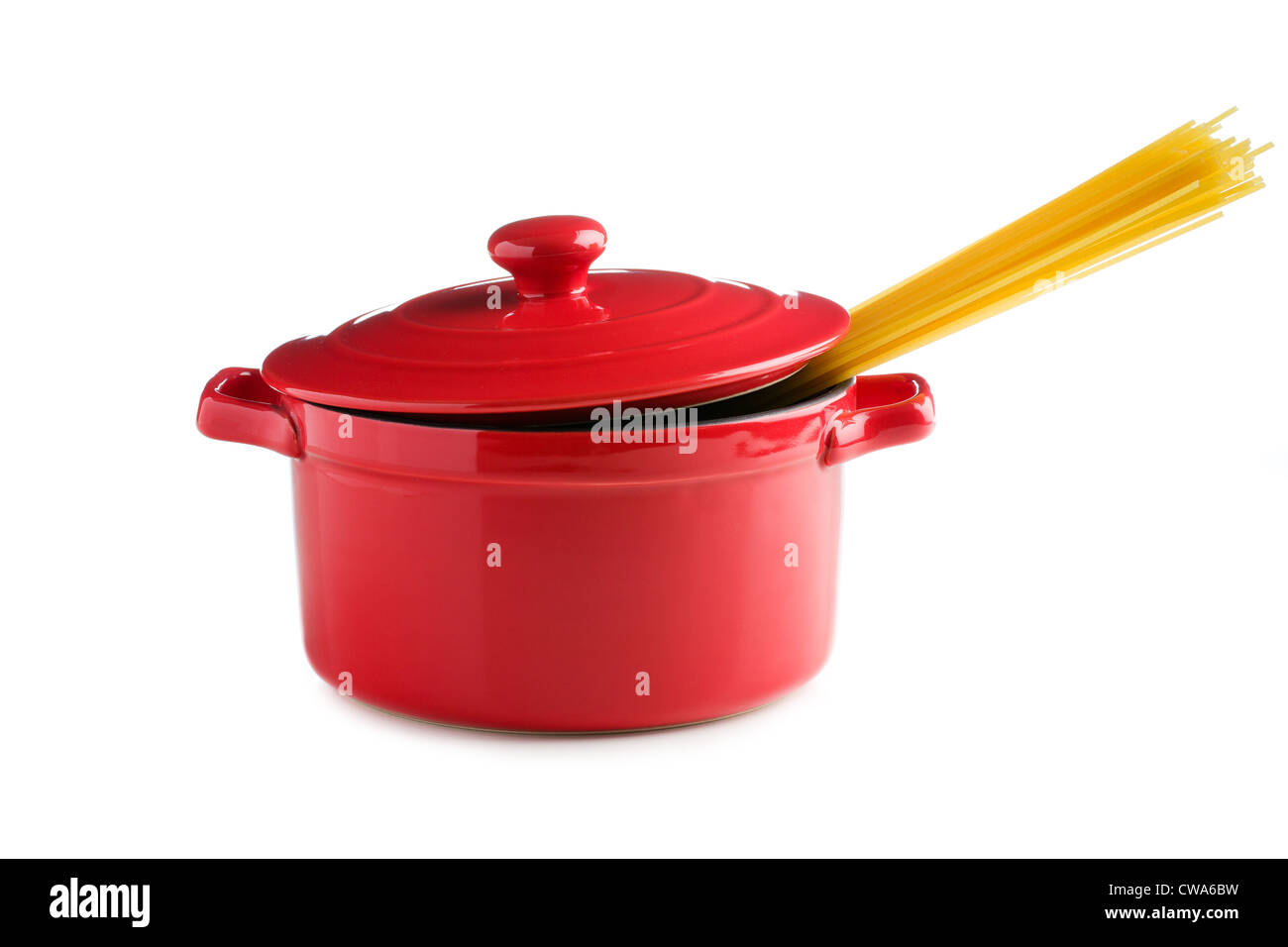 spaghetti in a red pot on white background Stock Photo - Alamy