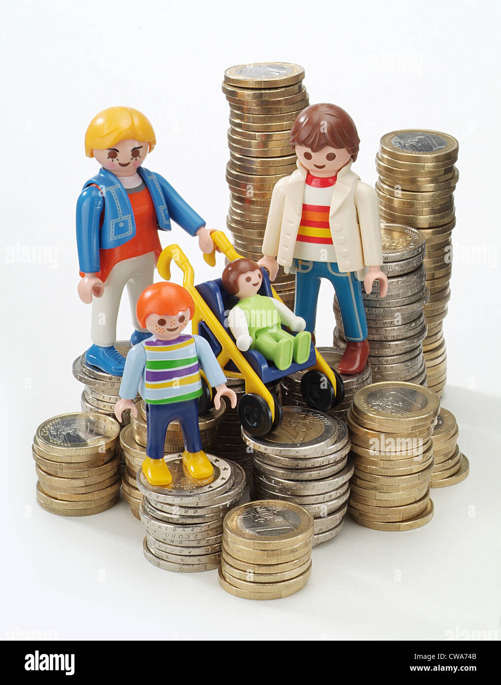 Figures of a family on piles of Euromuenzen Stock Photo - Alamy
