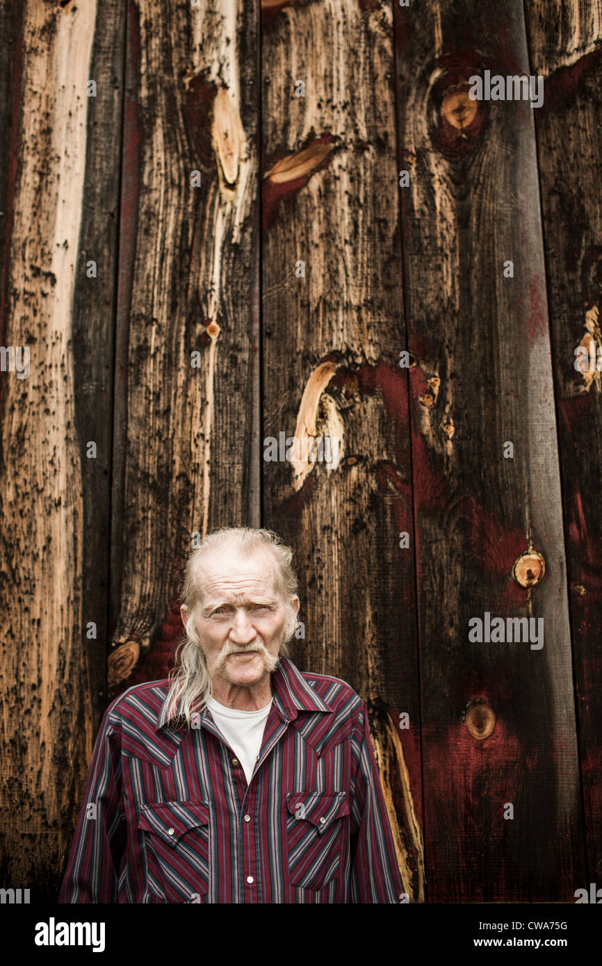 Senior man outside barn, portrait Stock Photo - Alamy