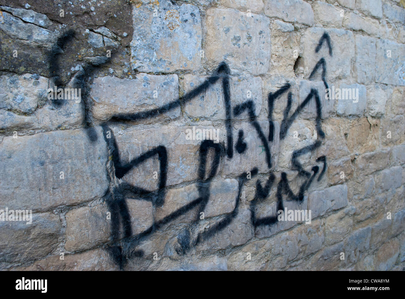 Graffiti tag 'Jax' sprayed onto an old stone wall Stock Photo - Alamy