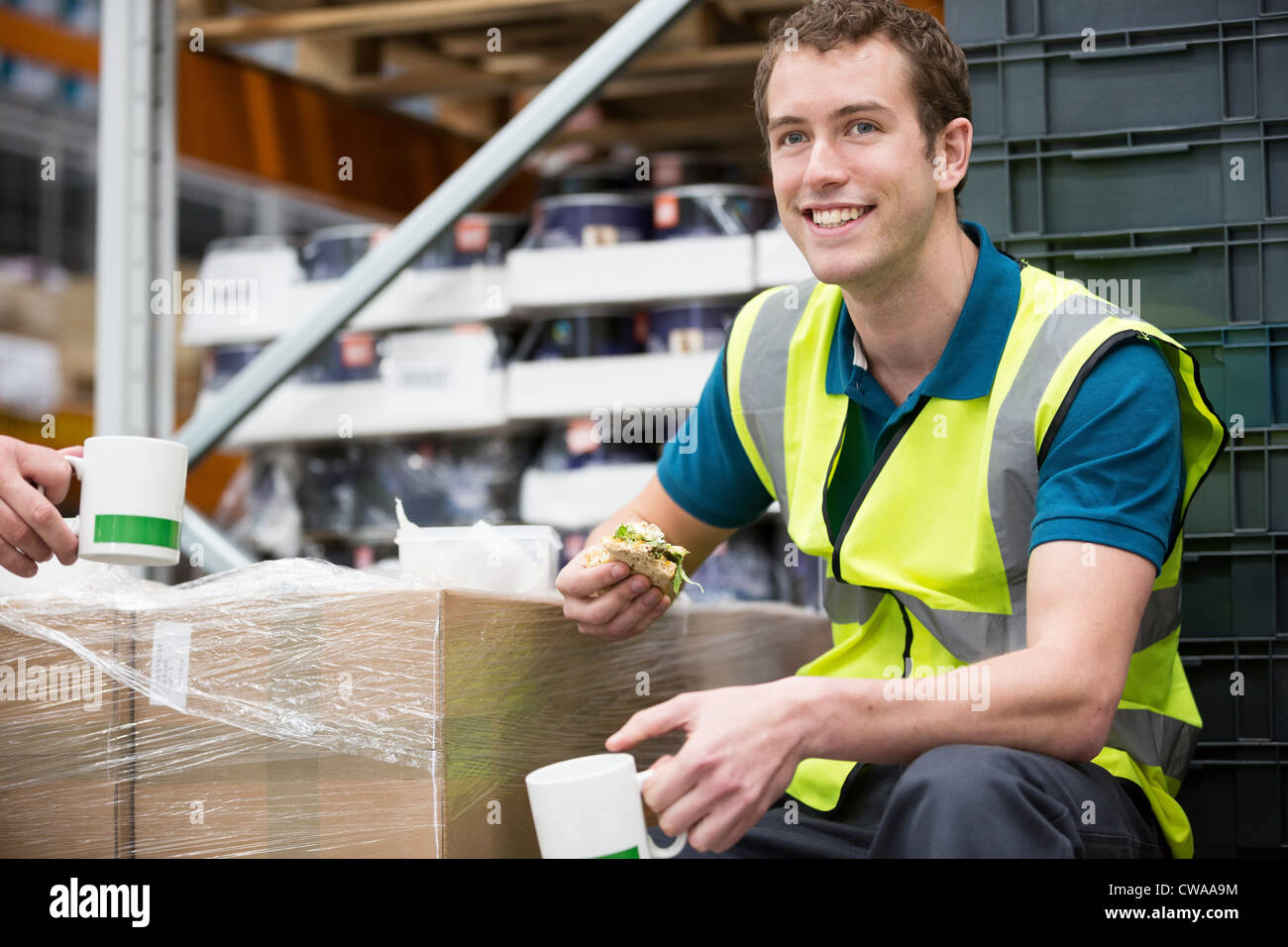 Men on lunch break in warehouse Stock Photo - Alamy