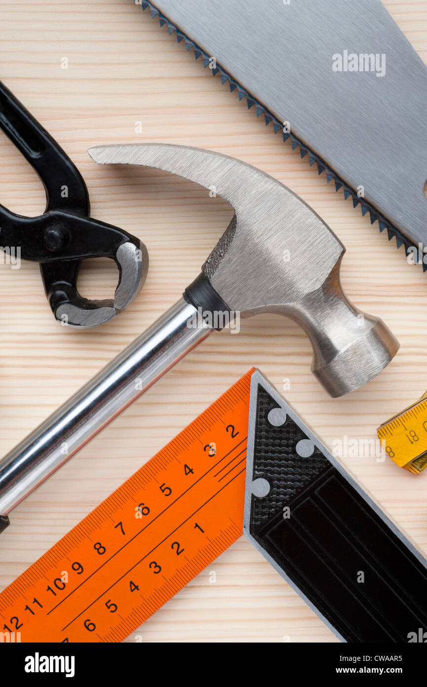 Assorted construction and measurement tools arranged on a wooden ...