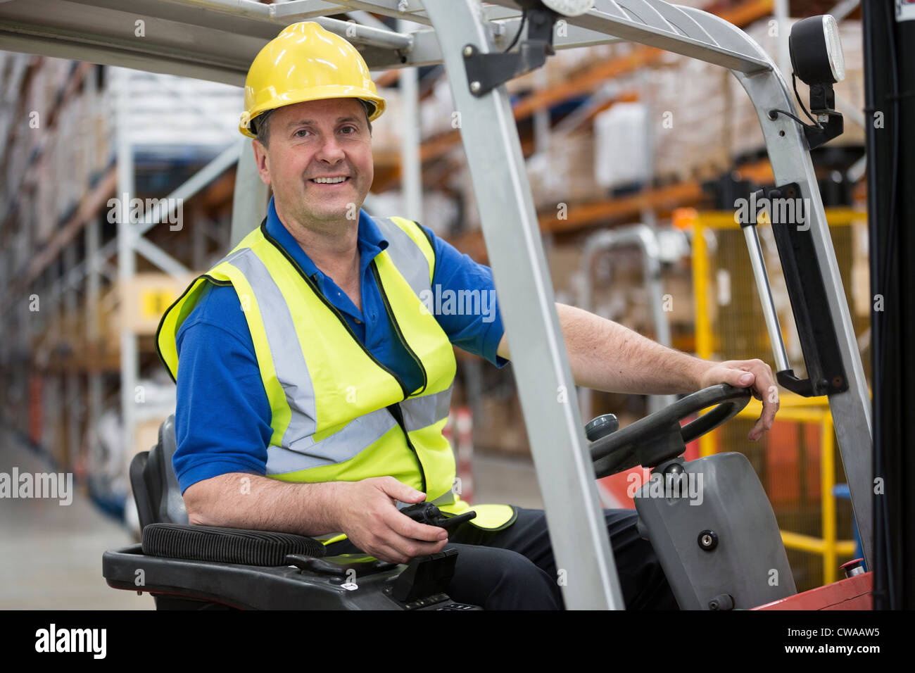 Man driving forklift truck Stock Photo - Alamy