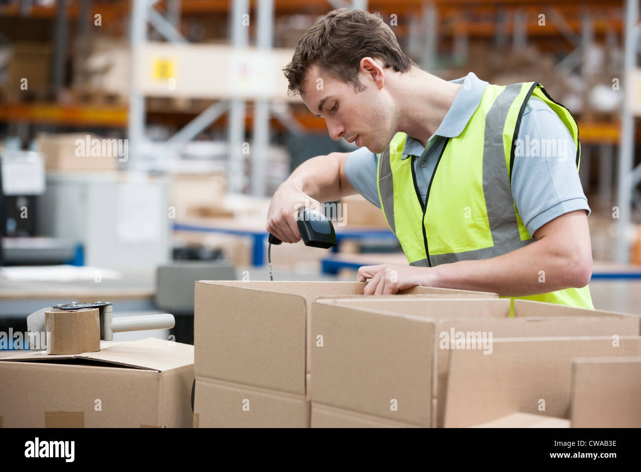 Man using barcode reader in warehouse Stock Photo - Alamy