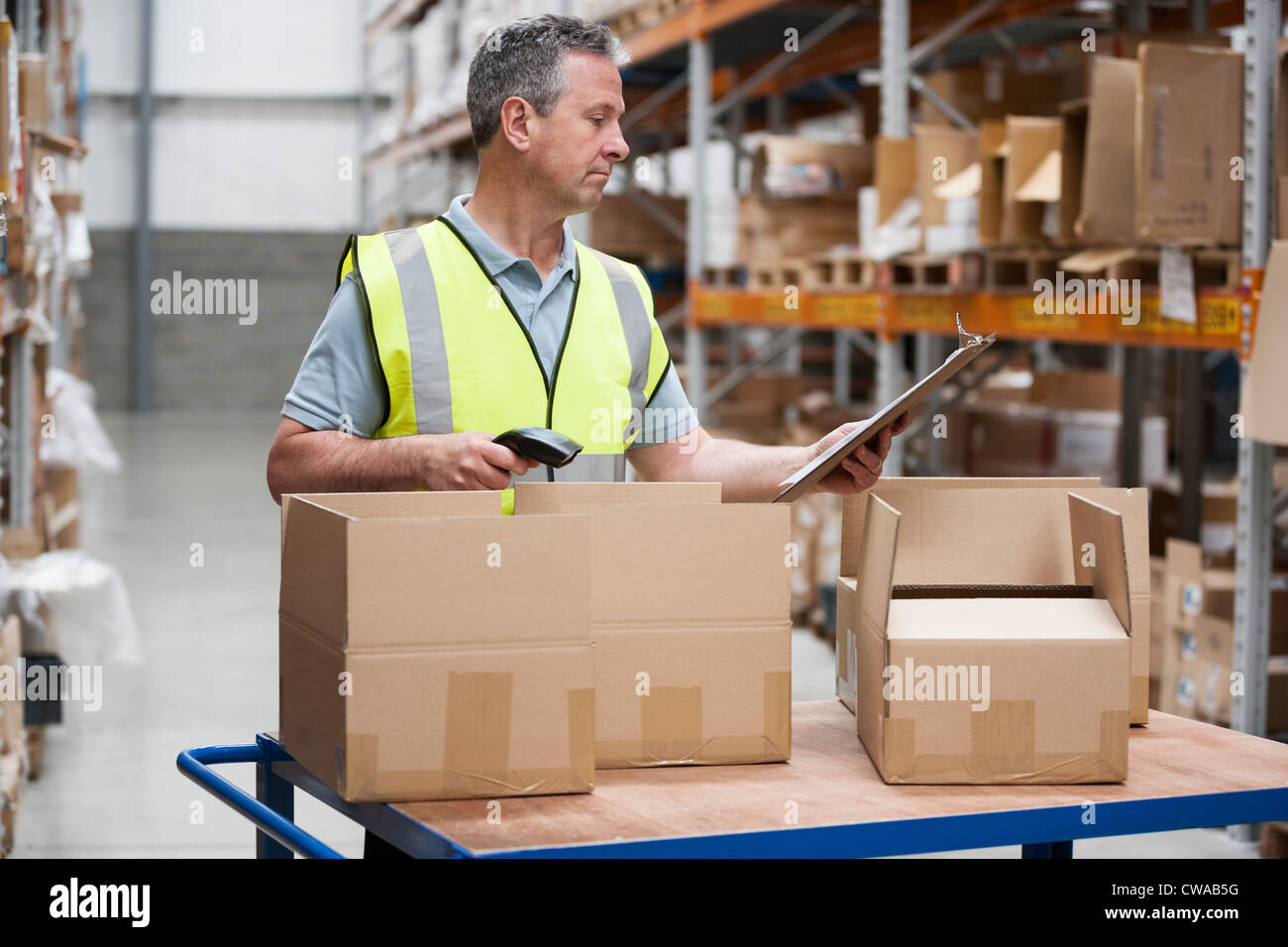 Man using barcode reader in warehouse Stock Photo - Alamy