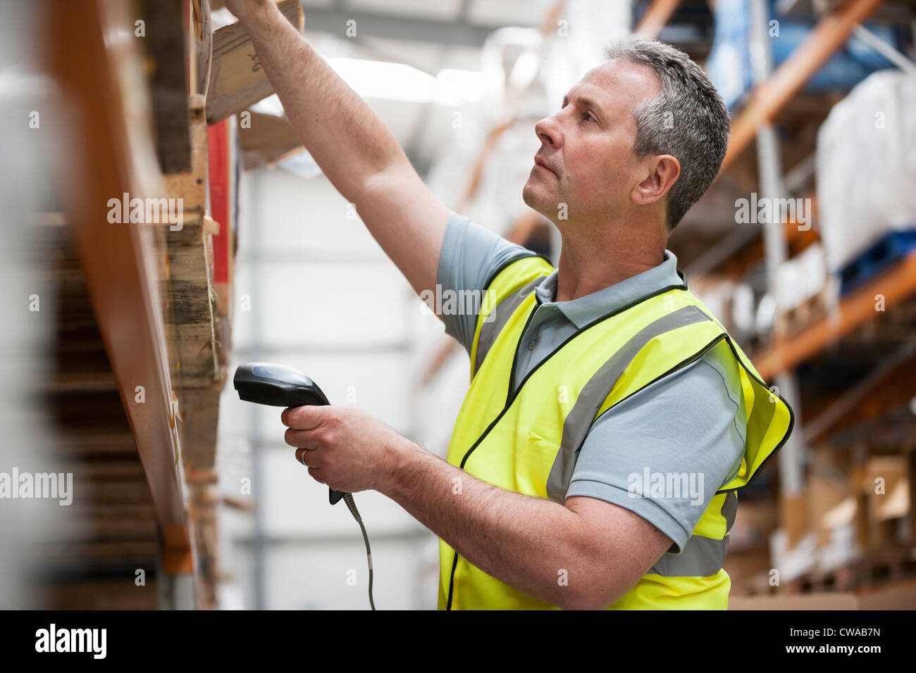 Man using barcode reader in warehouse Stock Photo - Alamy