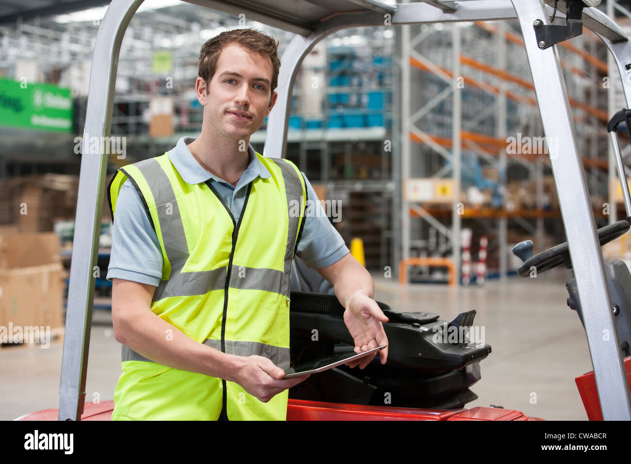 Man sitting with forklift truck, portrait Stock Photo - Alamy