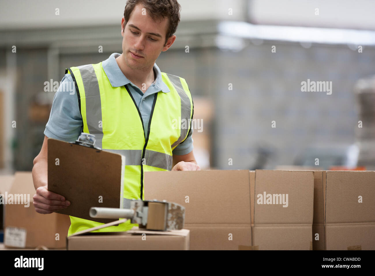 Man checking cardboard boxes Stock Photo - Alamy