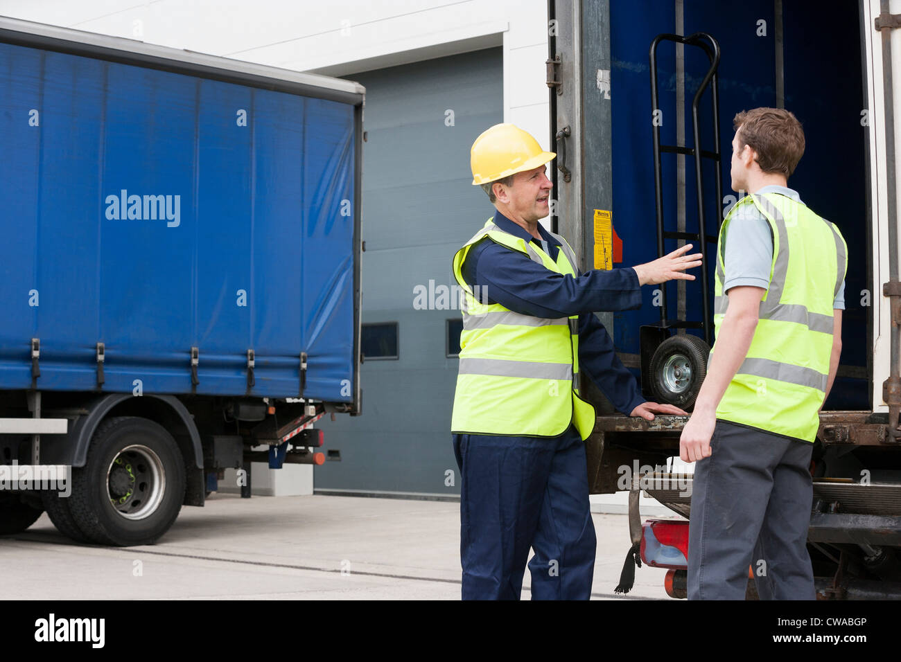 Two men loading truck Stock Photo - Alamy