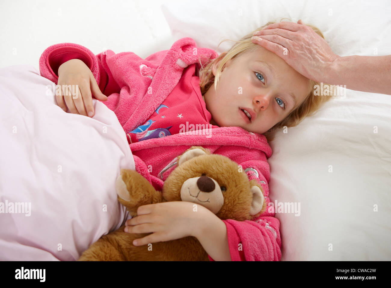 Parent touching girl's forehead Stock Photo - Alamy